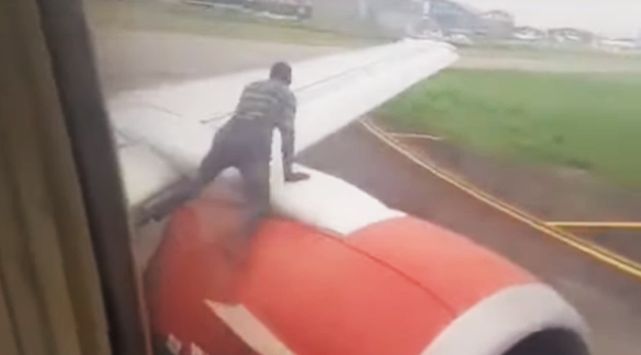 A Flight Gets Delayed When A Man Climbs Onto The Plane's Wing To Hitch ...